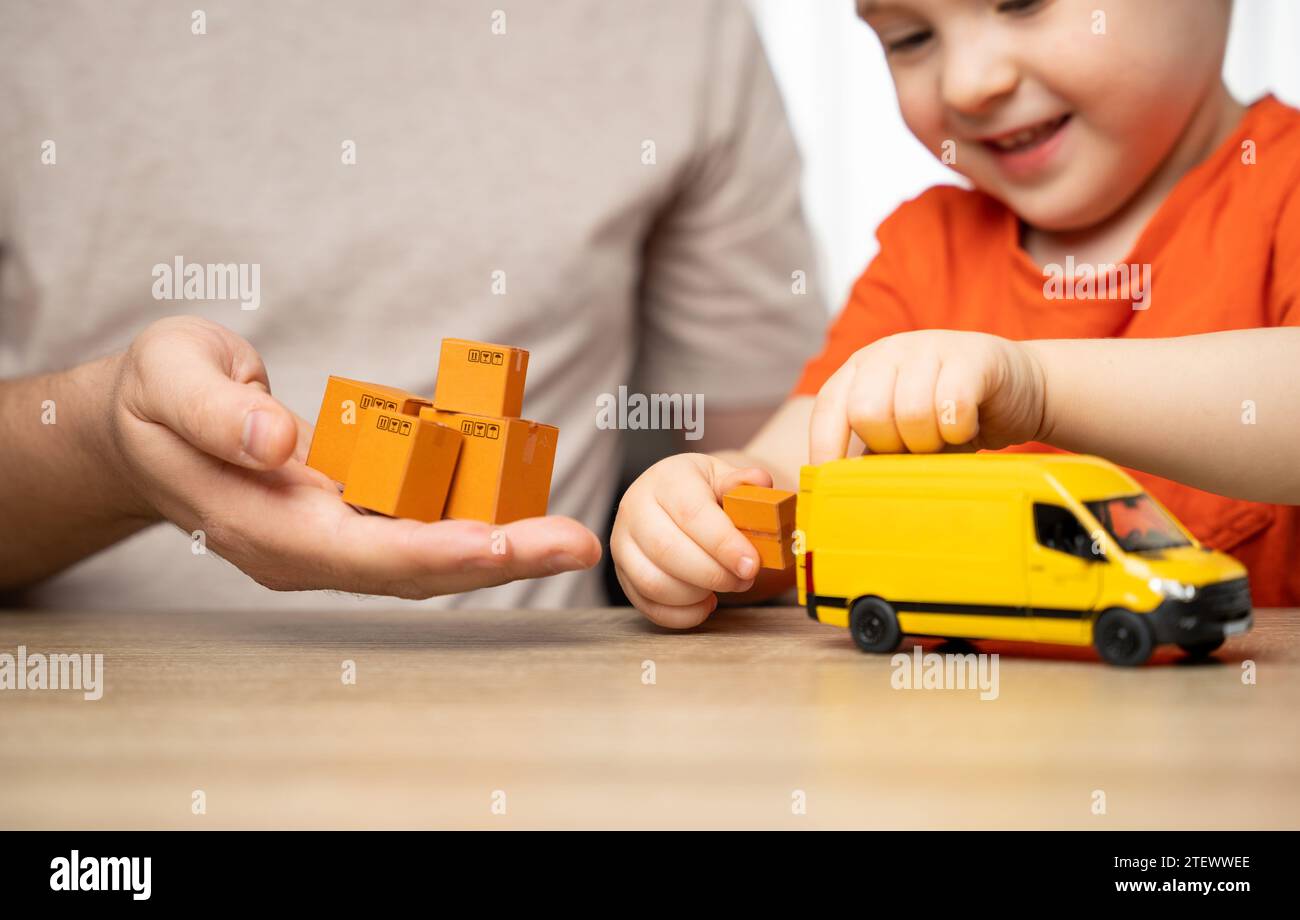 A child with his father and delivery of orders. Home business, shipping ...