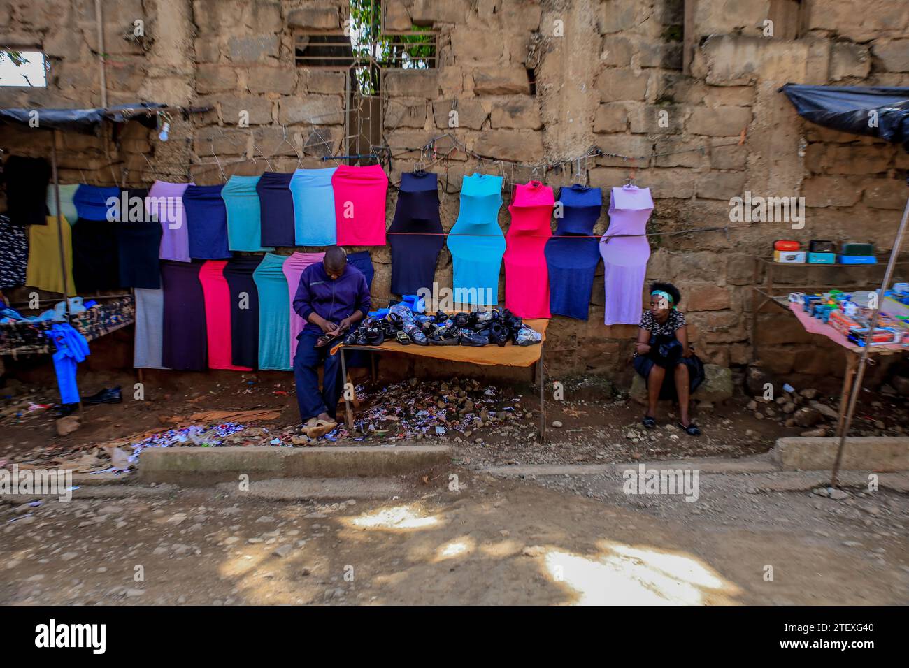 Hawkers sell second hand clothes by the streets in Kibera Slum, Nairobi ...