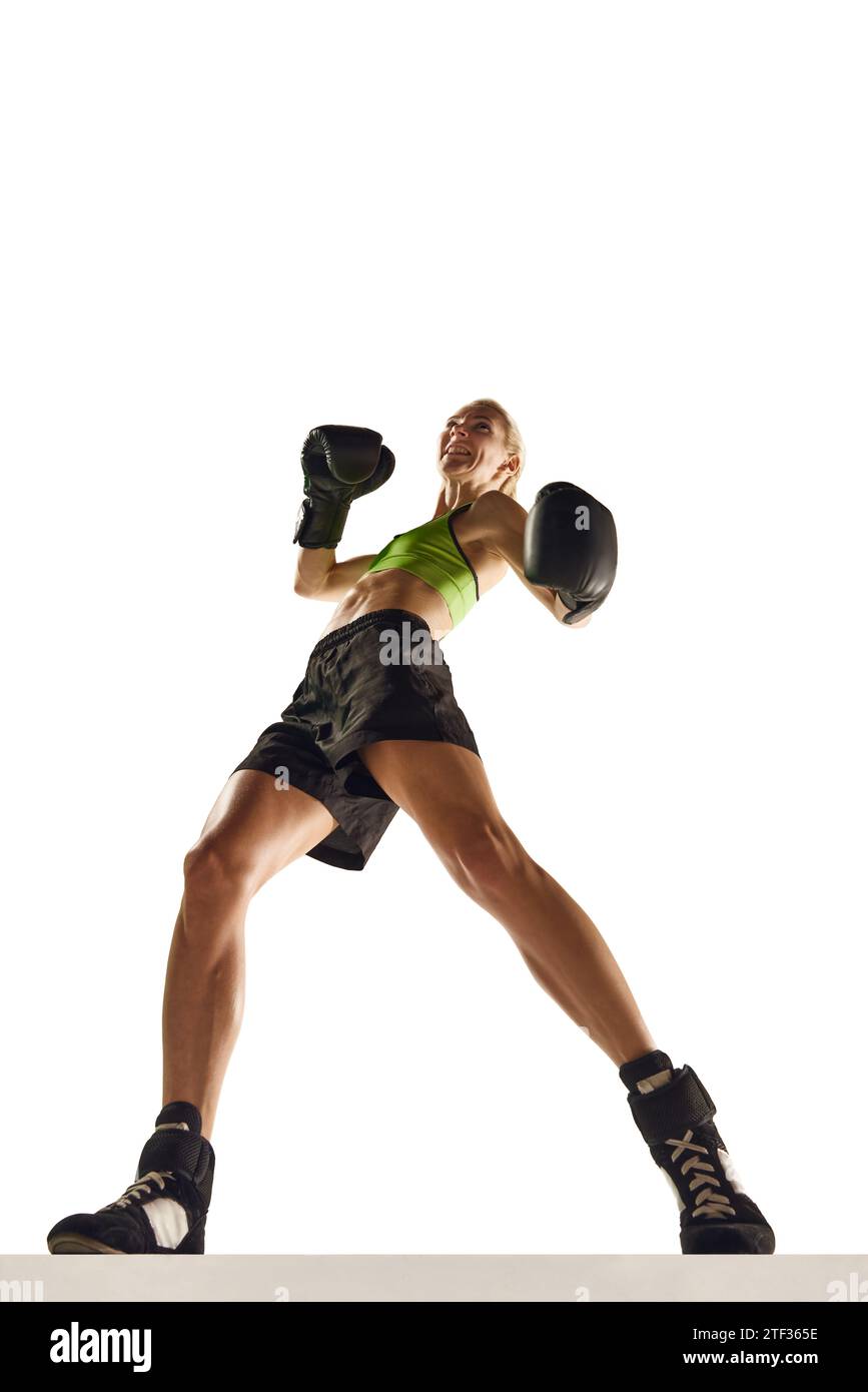 Bottom view of muscular young woman, boxing athlete in motion, training ...
