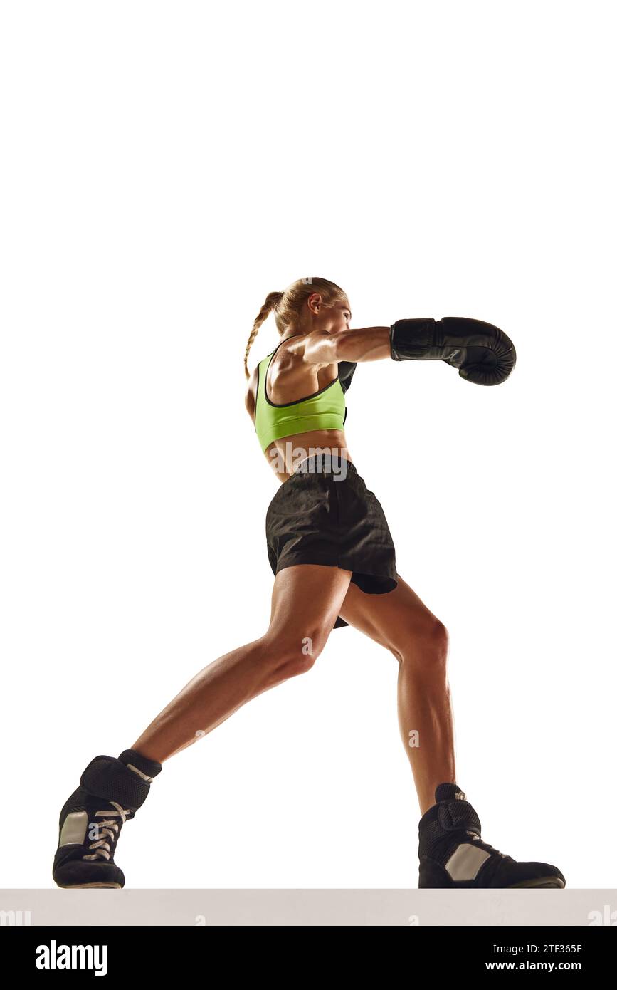 Bottom view of muscular young woman, boxing athlete in motion, training ...