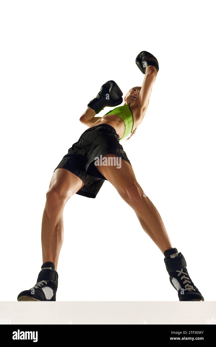 Bottom view of muscular young woman, boxing athlete in motion, training ...