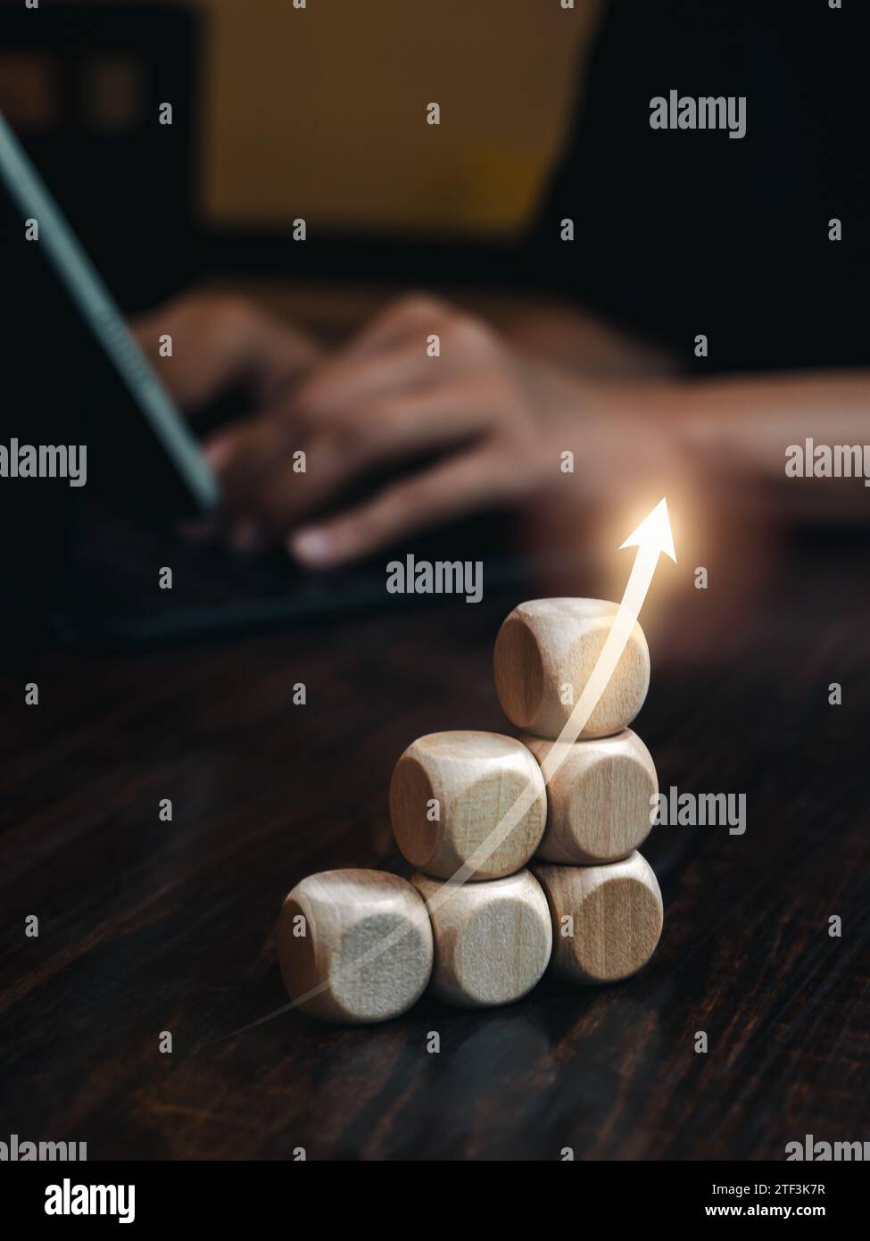 Rise upward arrow on wooden sticks bar graph chart steps on desk while ...