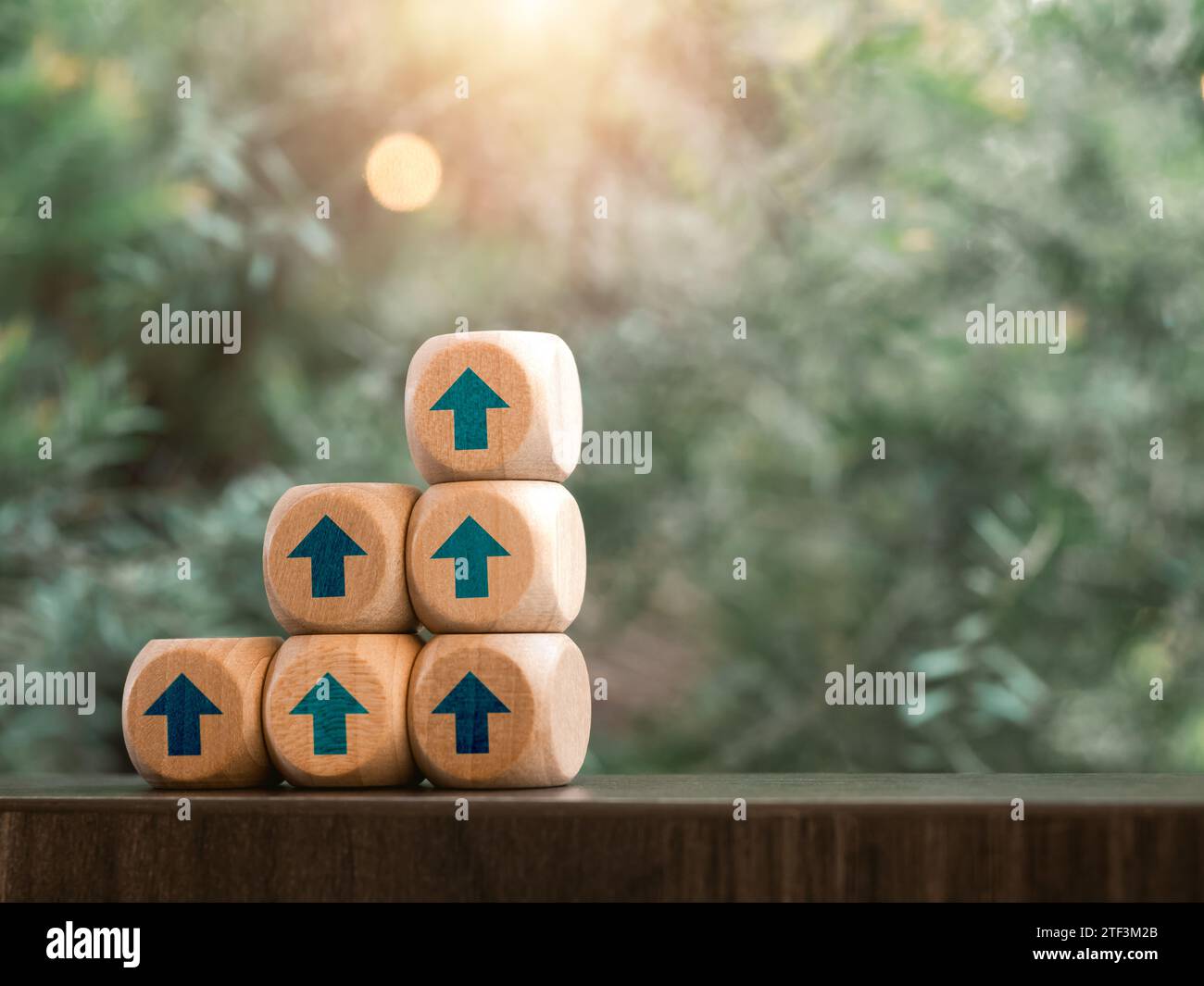 Rising up blue arrows on wooden cube blocks as a business graph or ...