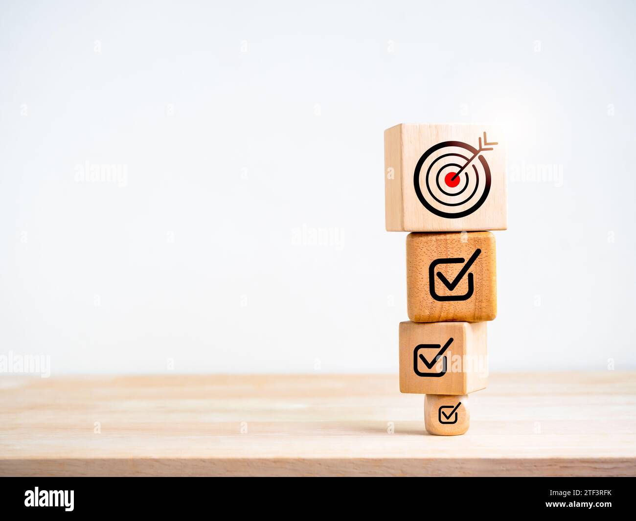 Business goal and success. Big target icon on top growth wooden block ...