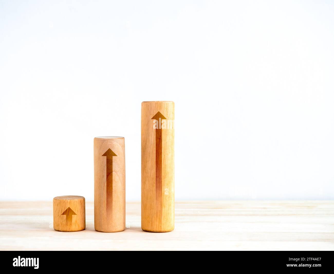 Upward arrow on round wooden sticks as business graph steps isolated on ...