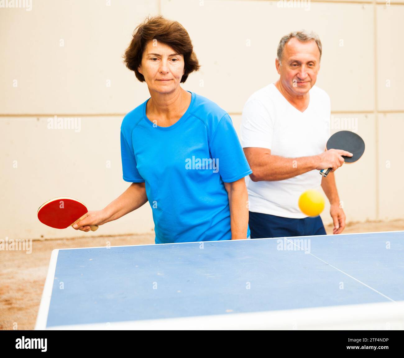 Mature couple playing ping pong outdoors at outdoor Stock Photo - Alamy