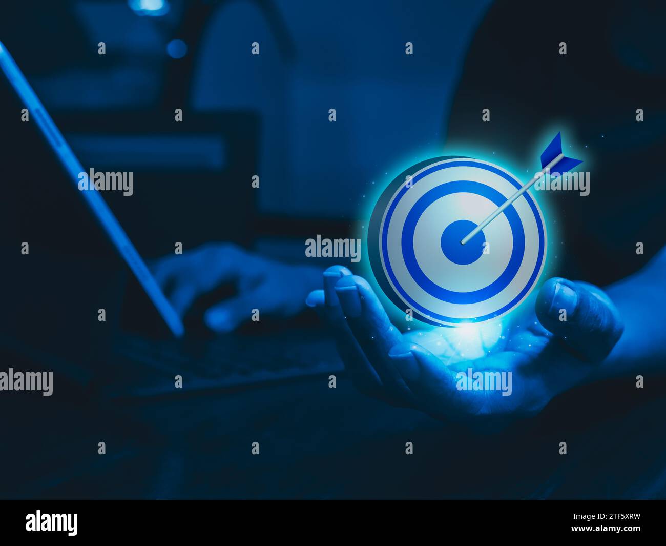 Businessman hand holding big goal, target dart icon while working with ...