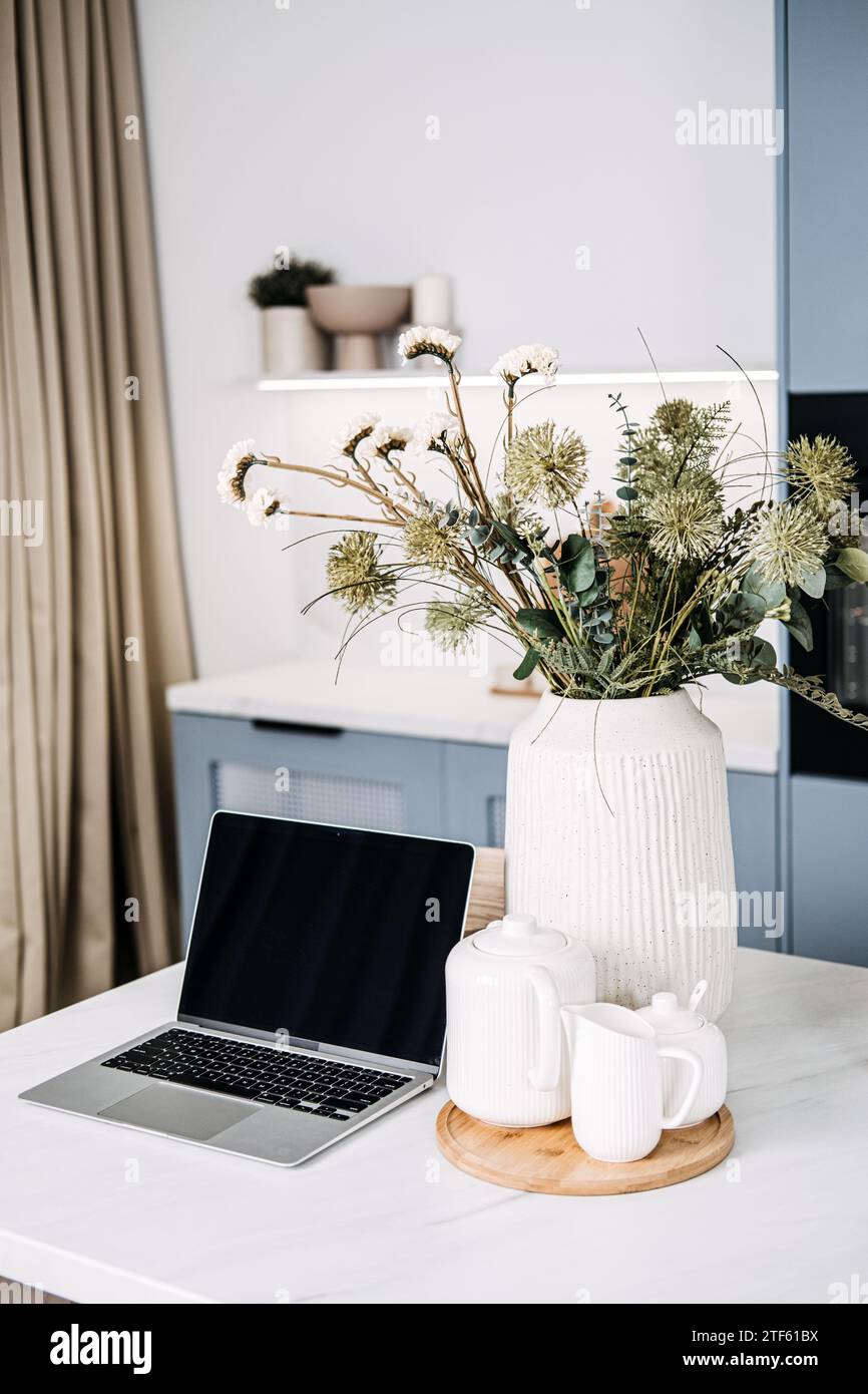 Home Office Setup with Laptop and Cozy Kitchen Decor. A chic home ...