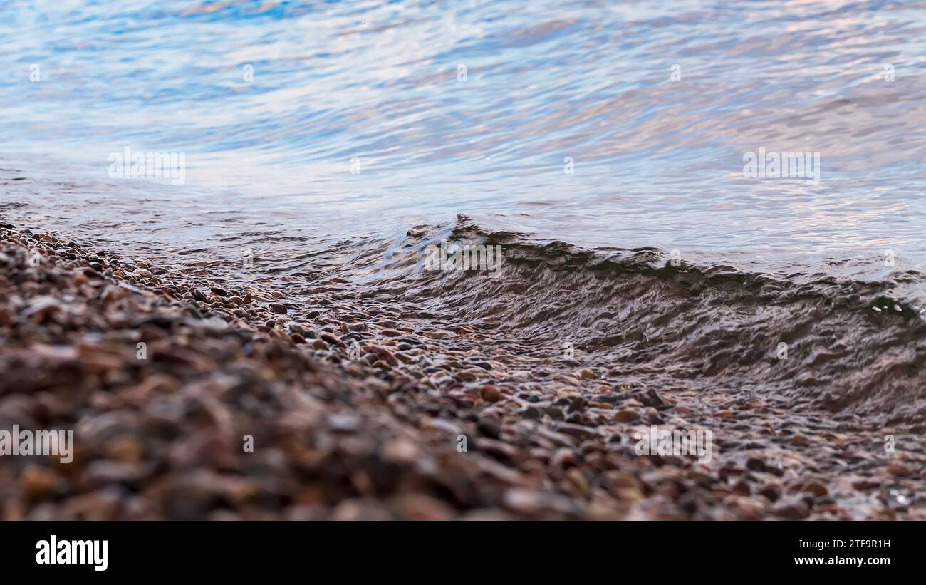 Natural background with sea wave and stones. Wave breaking on a rocky ...