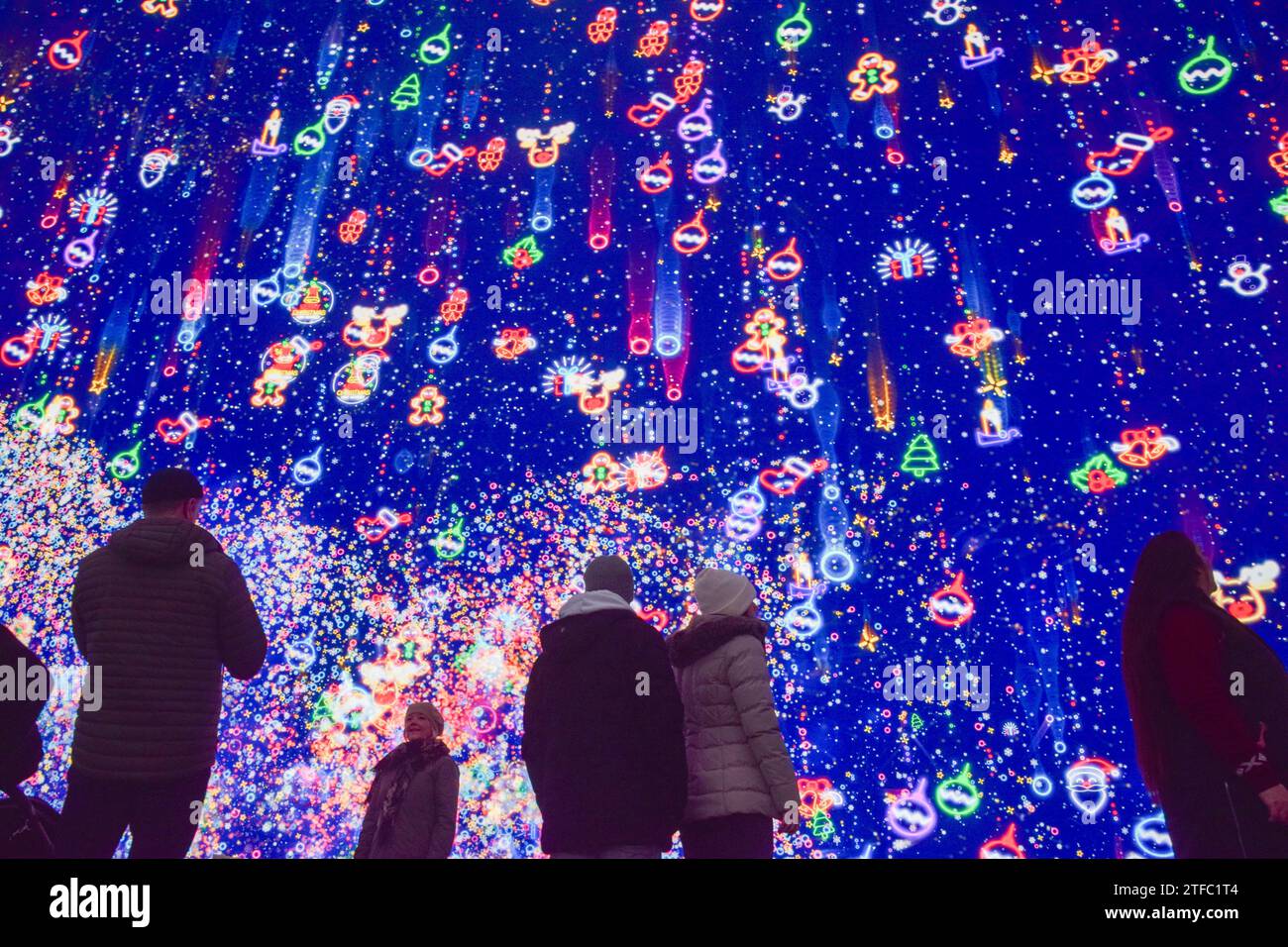London, UK. 20th December 2023. Visitors enjoy the Emoji Shower ...