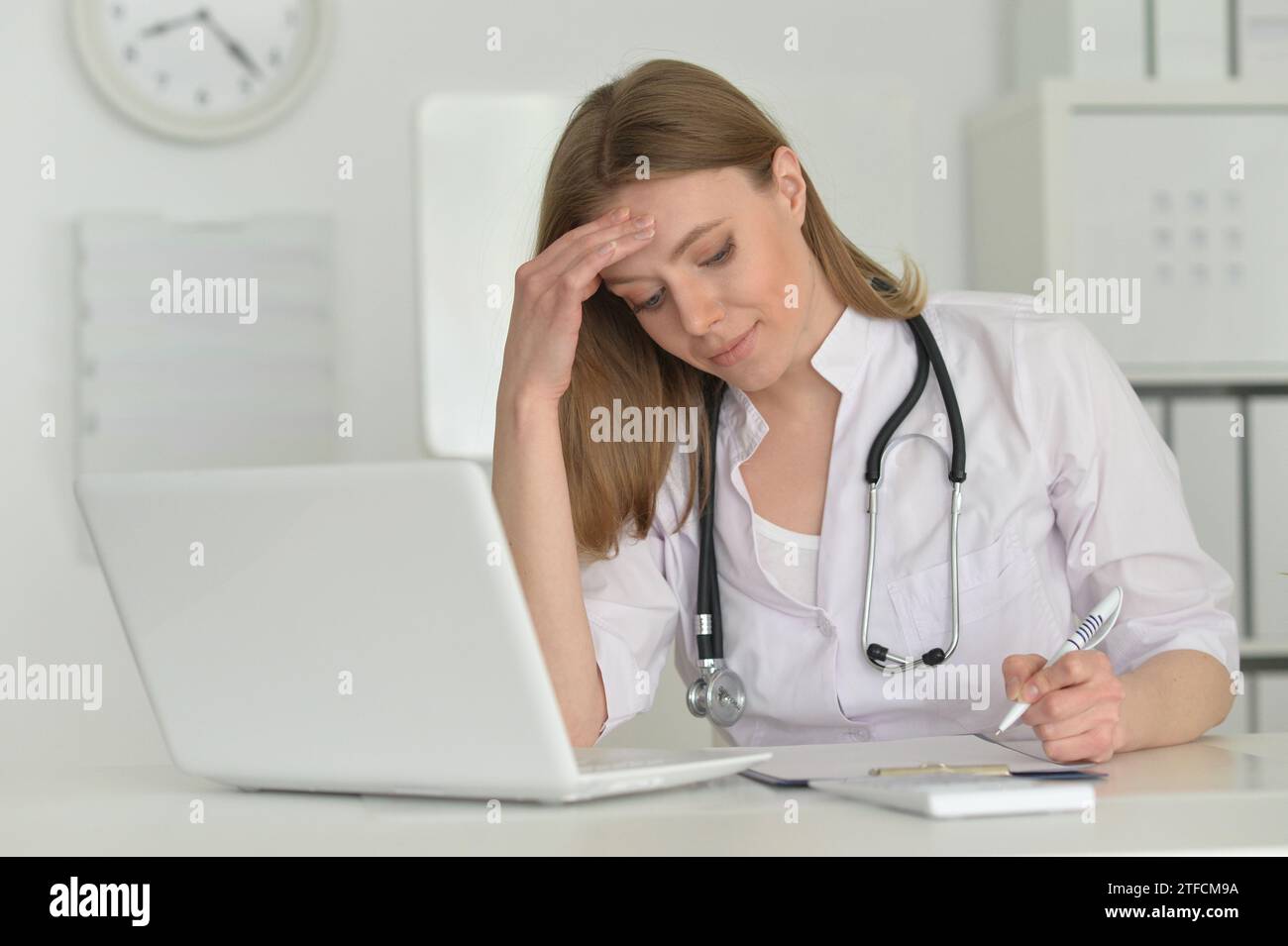 Young sad female doctor working in an office Stock Photo - Alamy