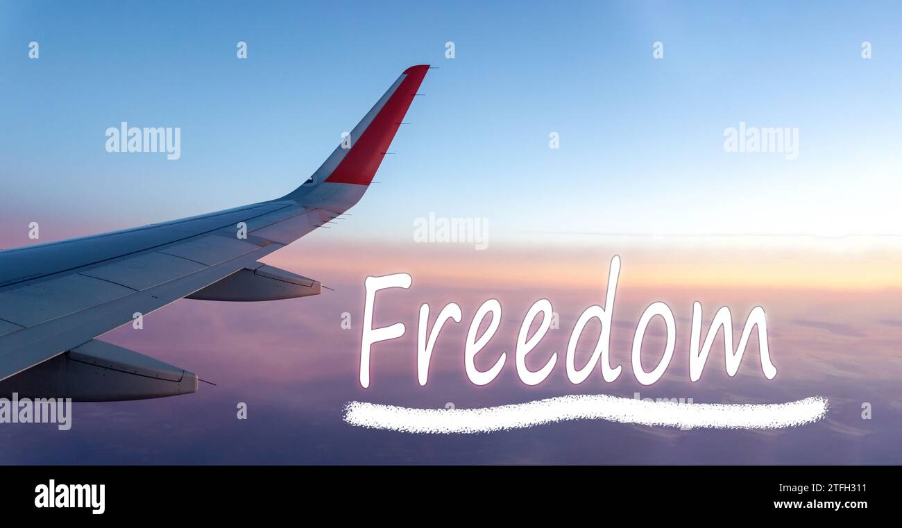 Airplane Wing Soaring Through the Sky, text Freedom. Banner copy space ...