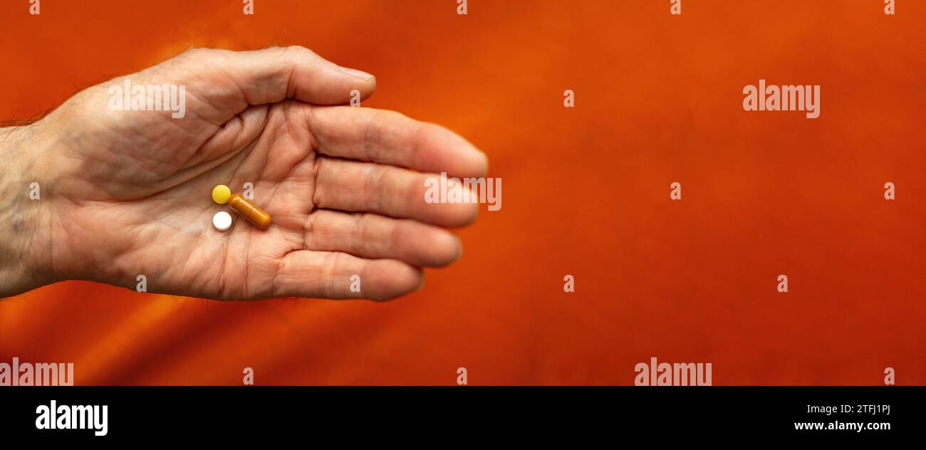 Close up view of senior male handholding pill. Supplements, longevity ...