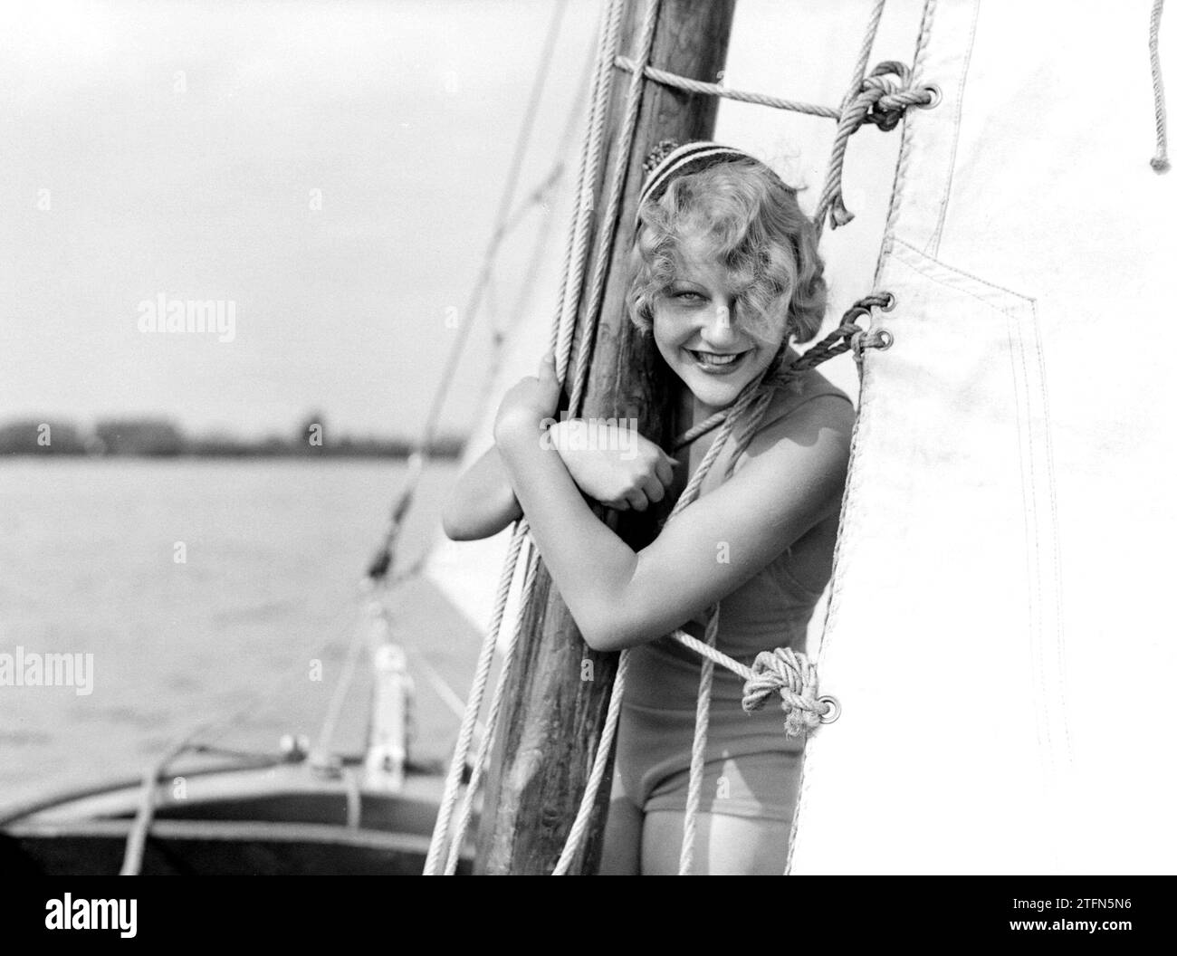 Model Eva Waldschmidt embraces the mast of a sailboat ca. 1932 Stock ...