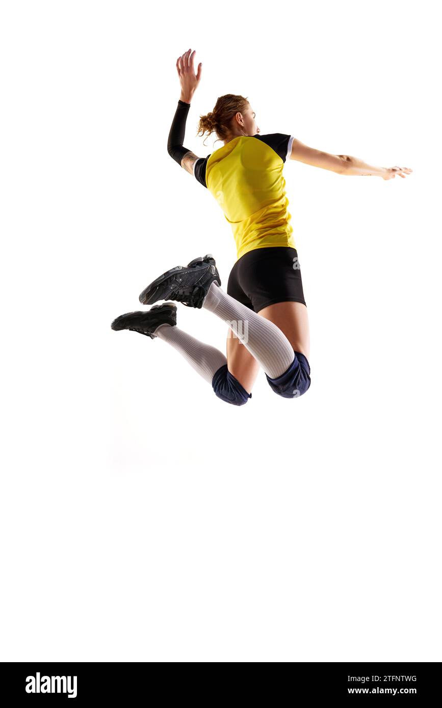 Full-length image of young athletic woman, volleyball player in motion ...