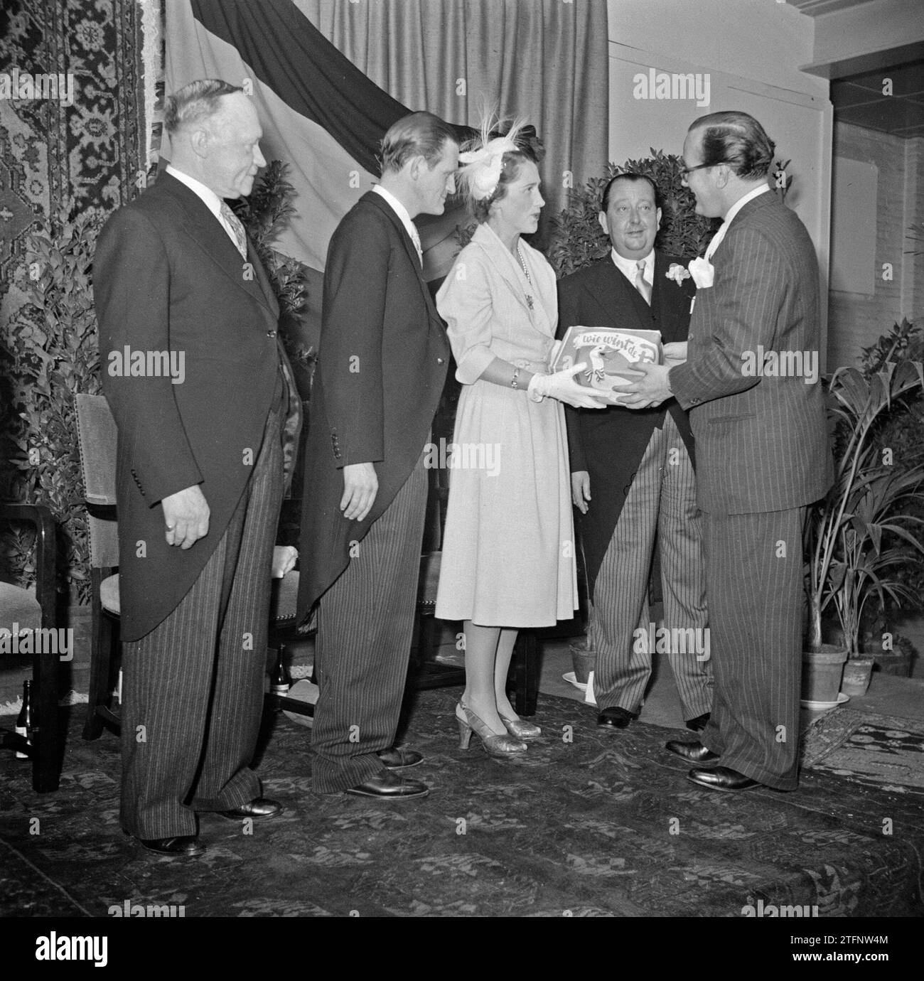 Man presents gift to woman, 2nd and 4th from left factory directors Jan ...