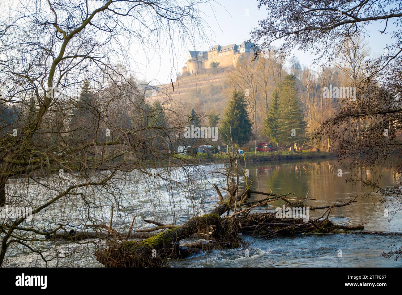 Strong river current with lots of rocks and shrubs in winter Stock ...