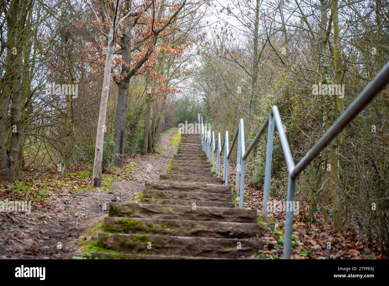 Steep stone steps of a staircase that goes steeply up with metal ...
