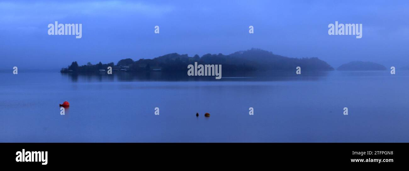 A misty dawn over Inchmurrin island, Loch Lomond from Duck Bay, Balloch ...