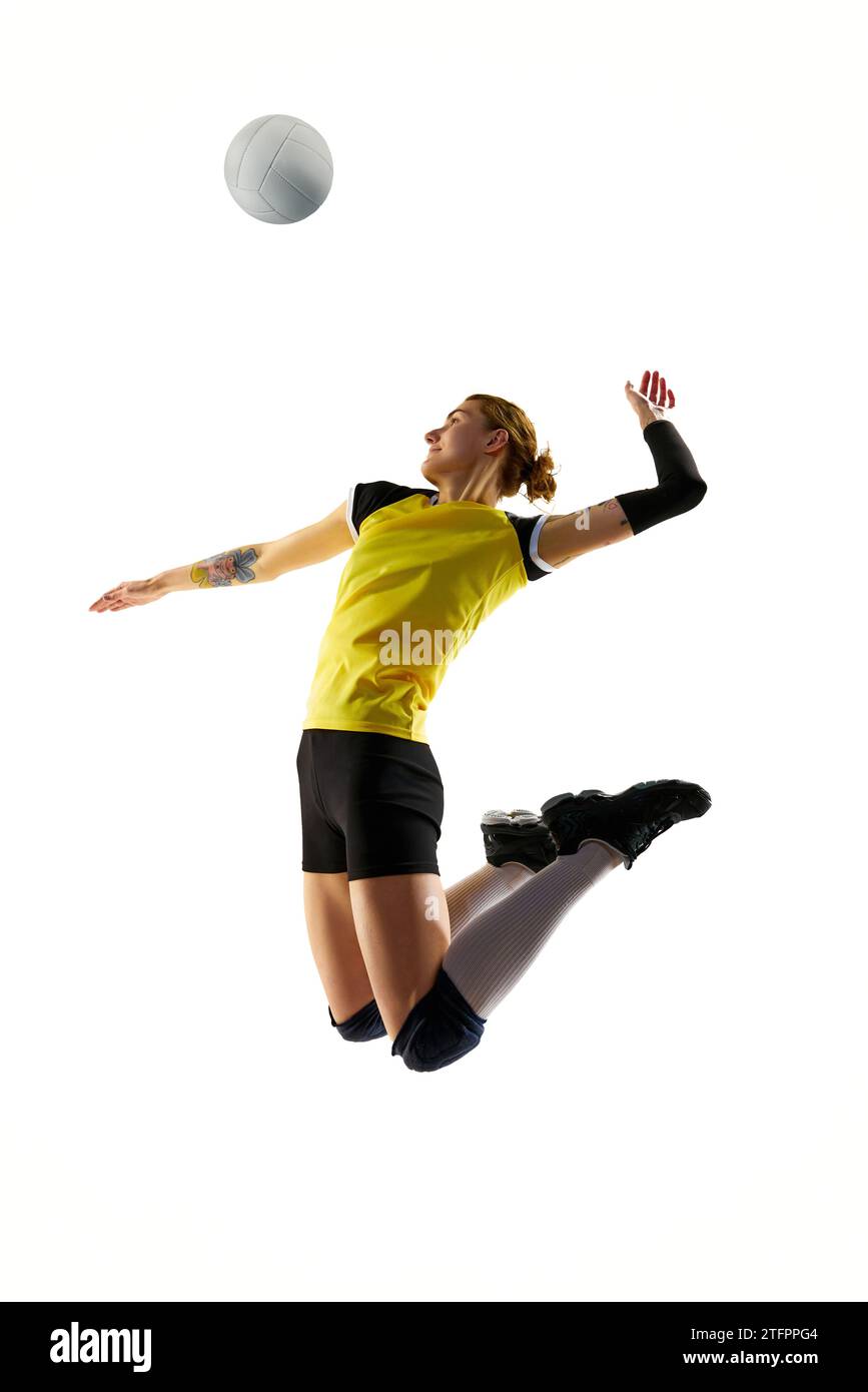 Full-length image of young athletic woman, volleyball player in motion ...