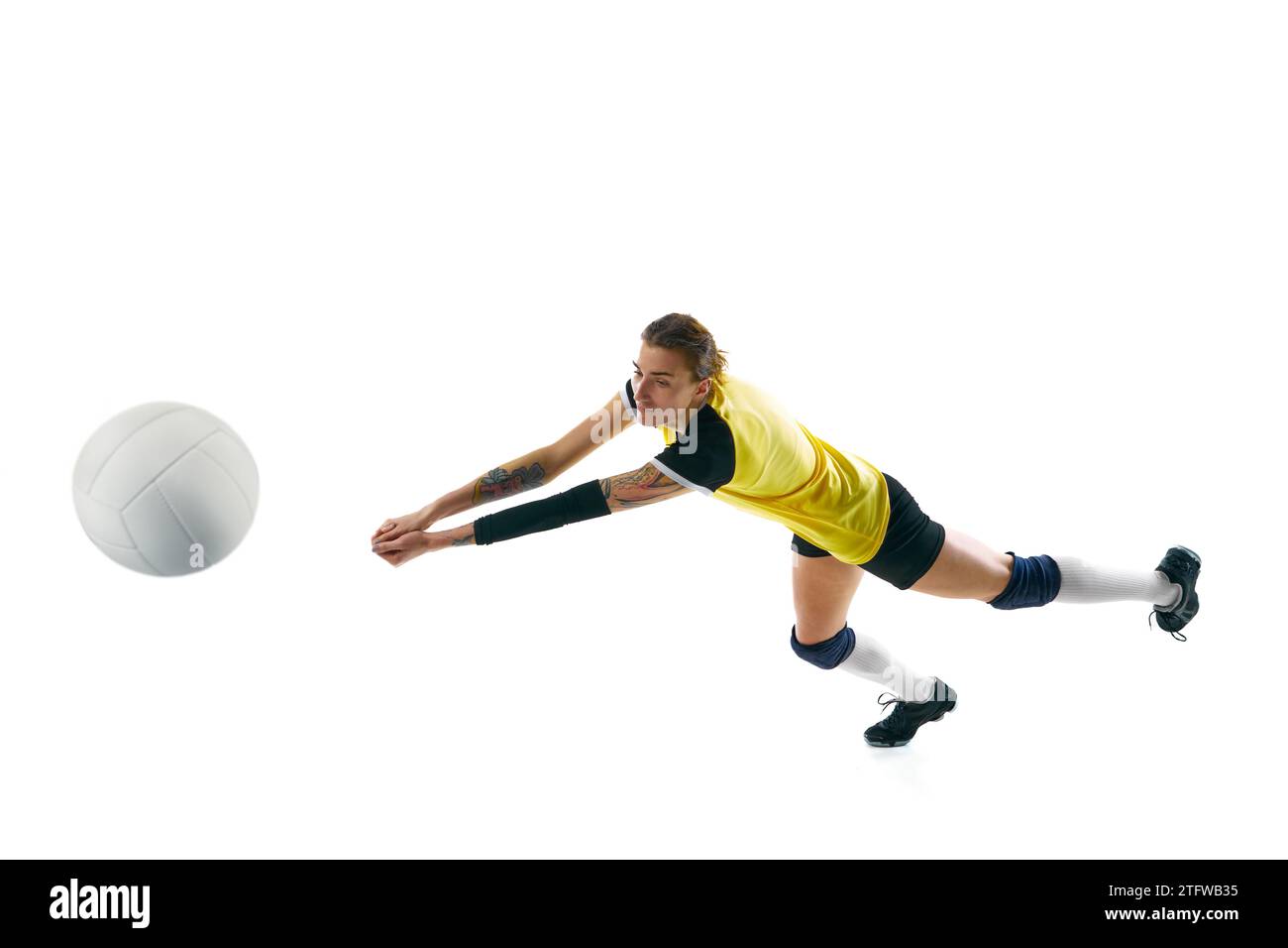 Young woman, volleyball player practicing, hitting ball in motion ...