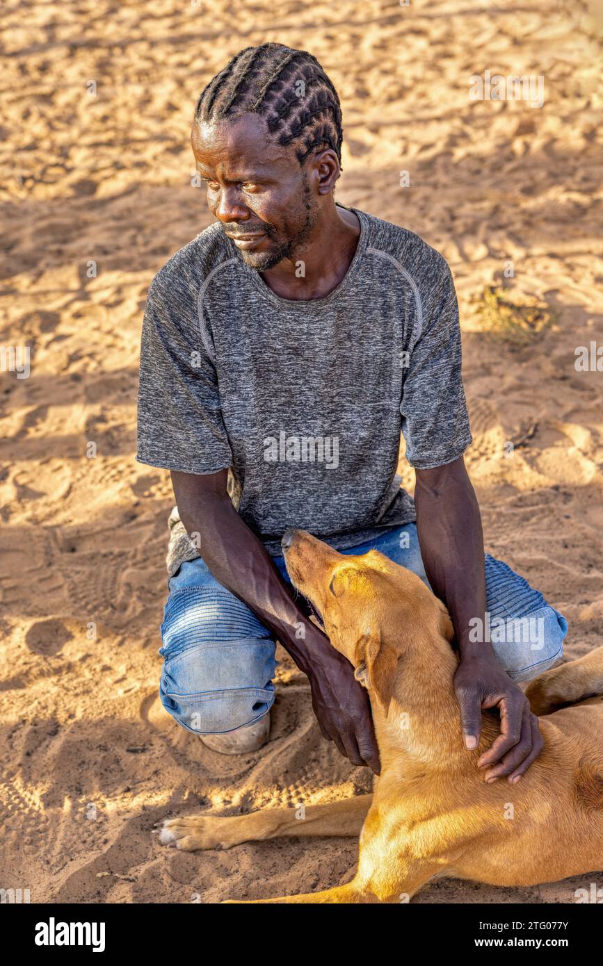 Africanis dog with his owner an african Tswana farmer wearing ...