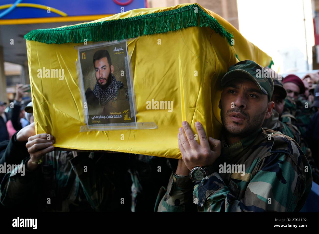 Hezbollah fighters carry the coffin of their comrade Mohammed Hassan ...
