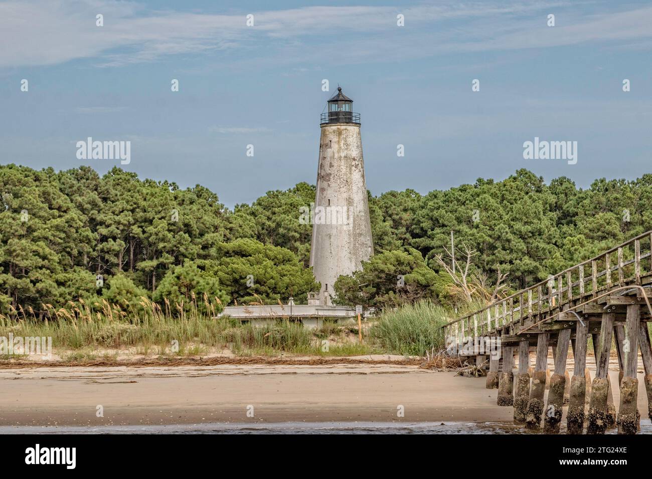 Old lighthouse and pier Stock Photo - Alamy