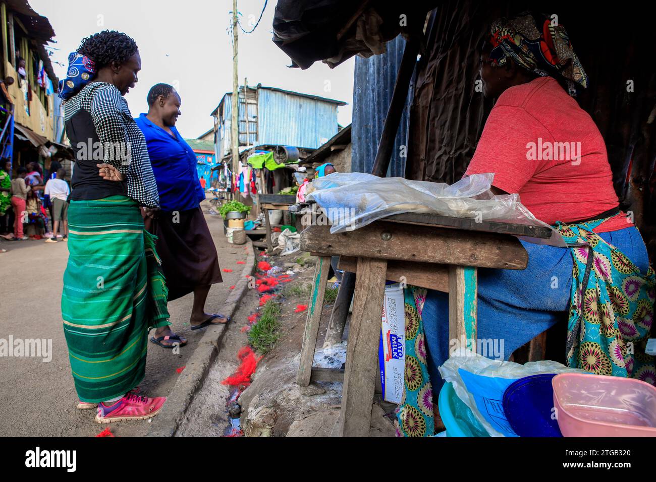 Women exchanging conversations in Kibera Slum. A view through the ...