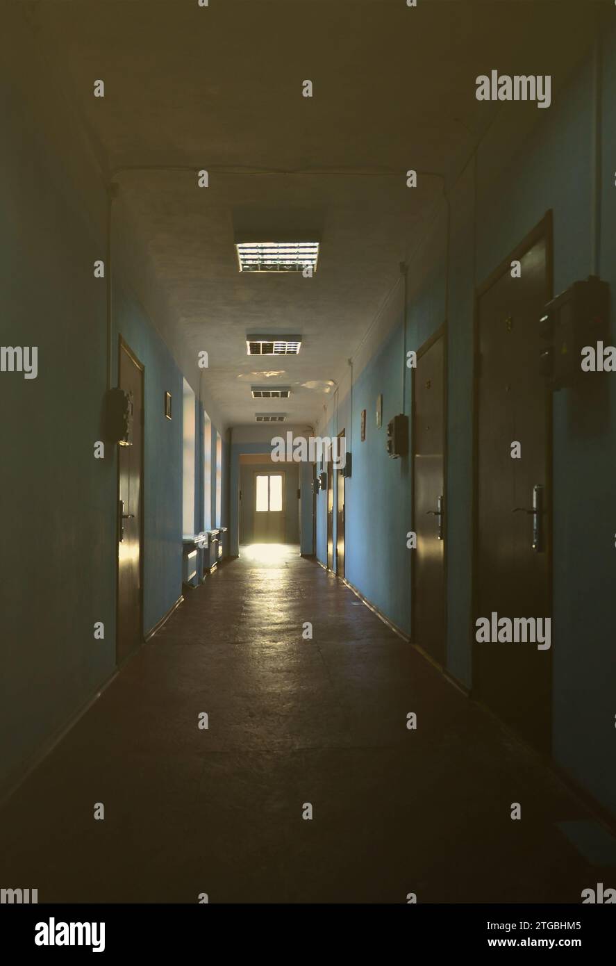 The gloomy corridor of a neglected public building. Public space in a ...