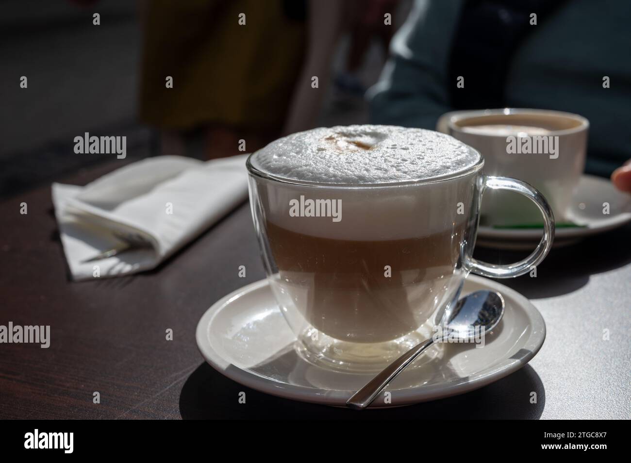 Drinking of tasty fresh brewed Italian caffe latte coffee with whipped ...
