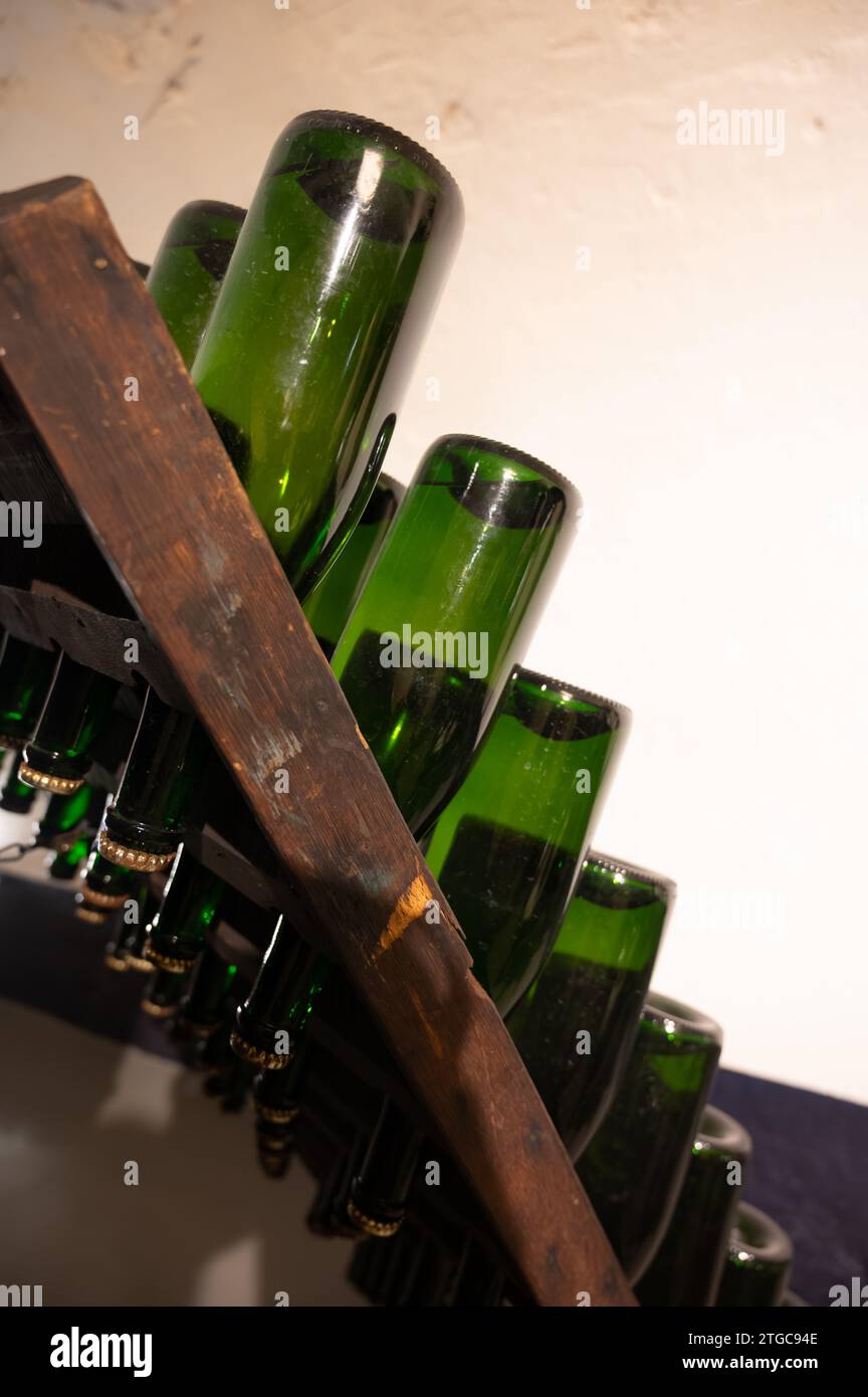 Wooden pupitre with bottles. Traditional method of production of ...