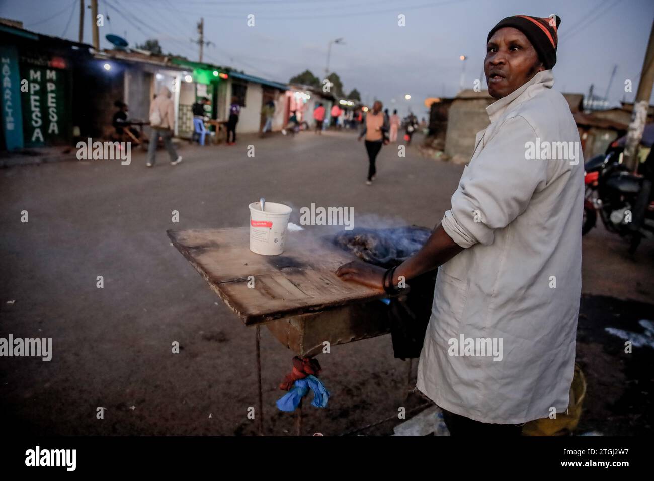 NAIROBI, Africa. 19th Dec, 2023. A man selling street food in Kibera ...