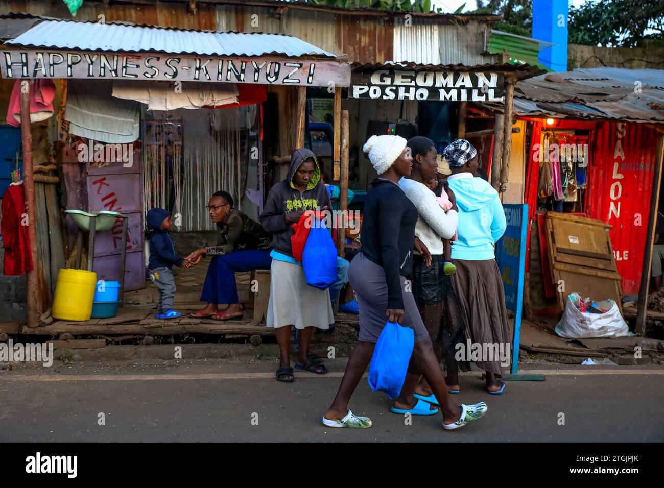 Pedestrians walk past the busy streets in Kibera Slum of Nairobi, Kenya ...