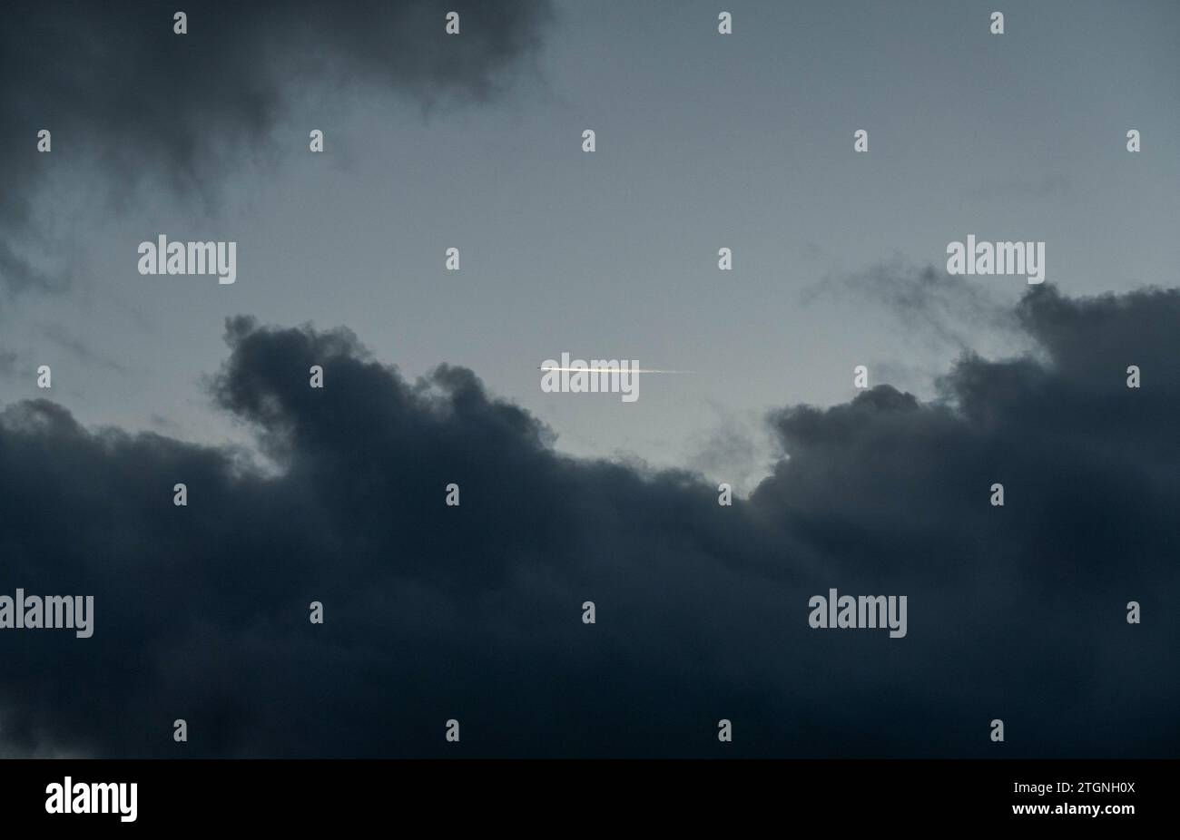 Passenger jet flying above storm clouds Stock Photo - Alamy