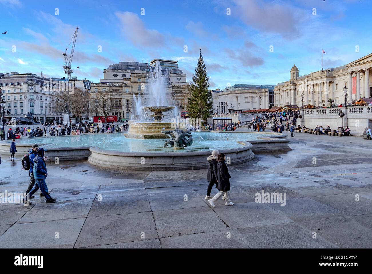 Visitors stroll around the Christmas Tree in Trafalgar Square, central London, Britain, on ...