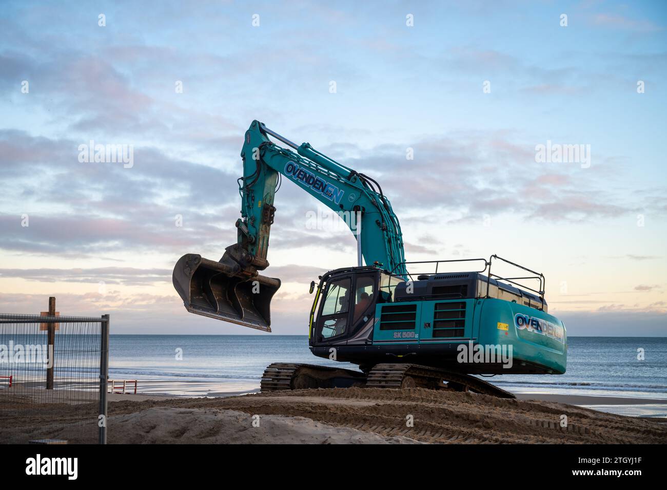 Maintenance diggers Bournemouth beach arranging sand around new ...