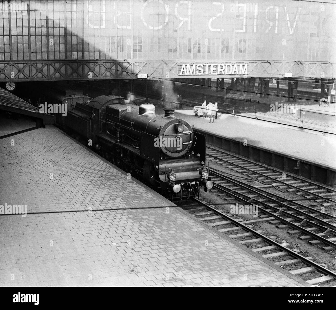 Steam locomotive seen from a bird's eye view along the platform of the ...