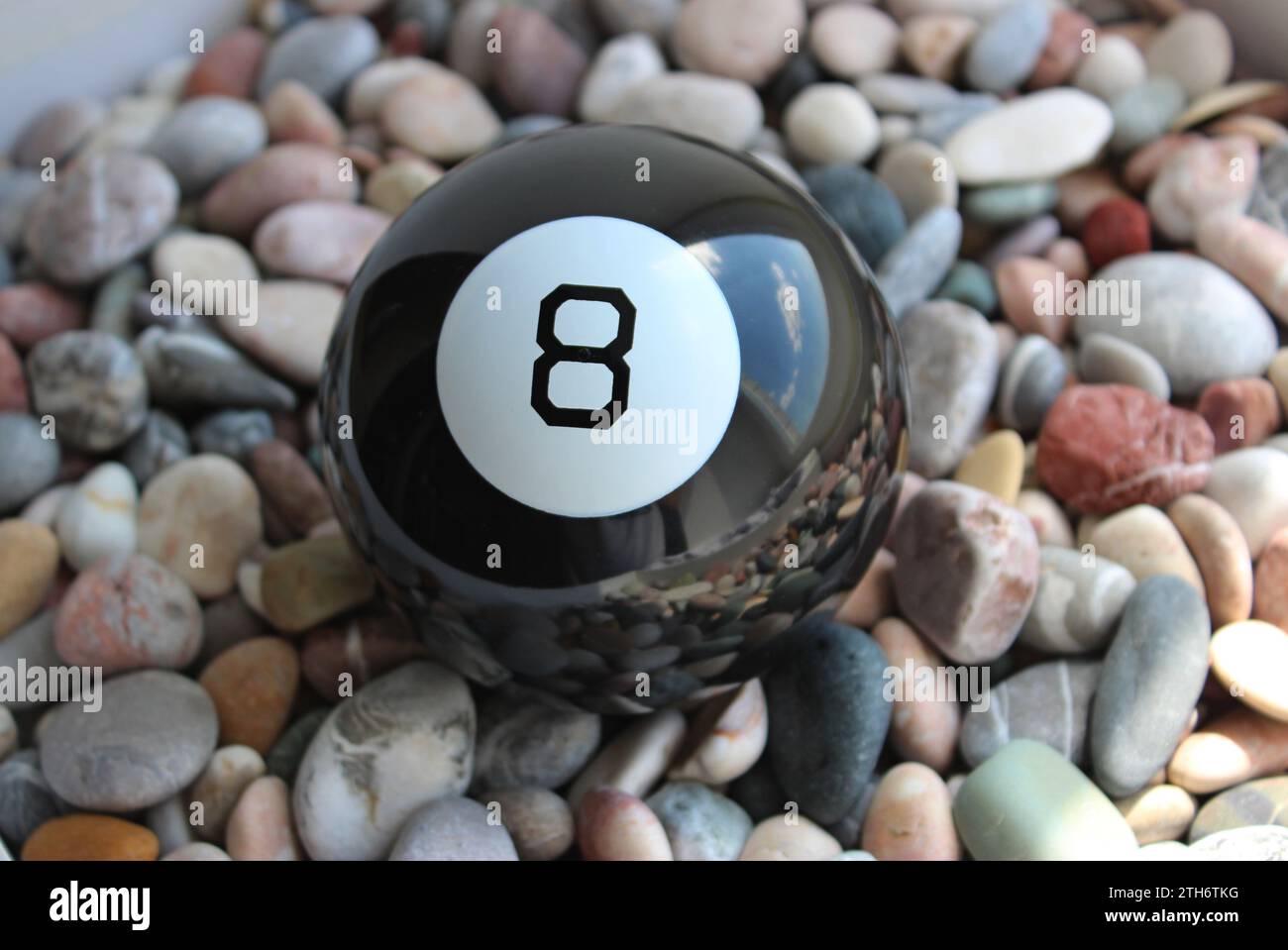 Black Billiard Ball Number Eight Lying On A Colored Smooth Pebbles Top ...