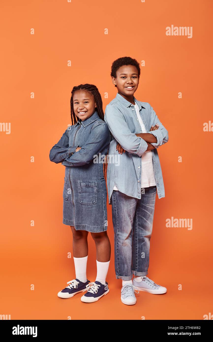 happy african american children in casual denim attire standing with ...