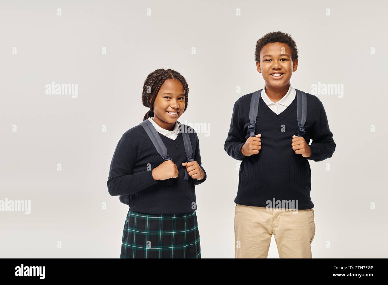 happy african american schoolchildren with backpacks standing in neat ...