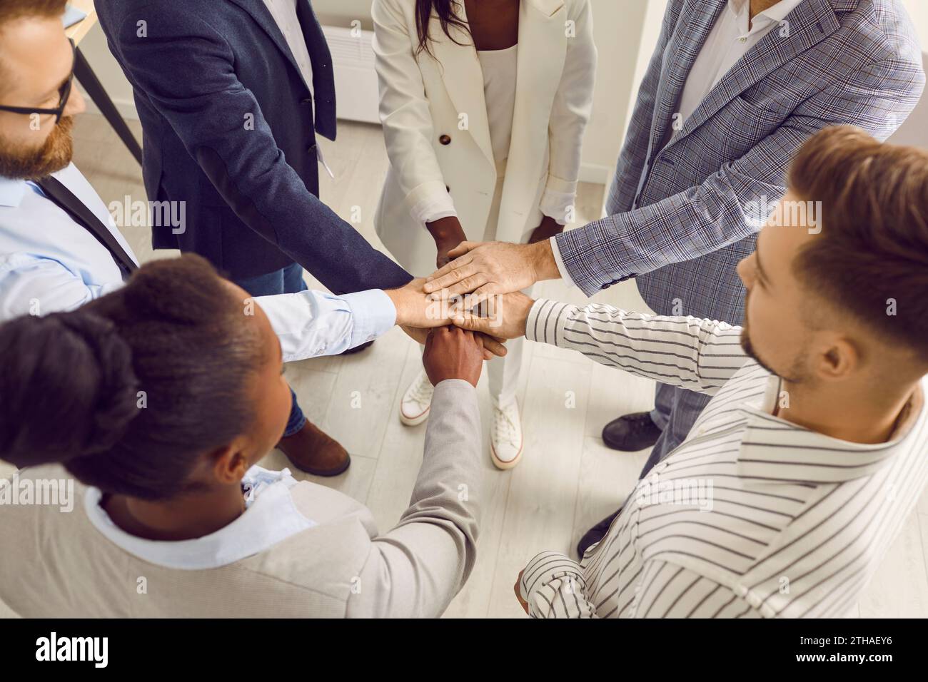 Close up top view photo of diverse business people putting their arms together in stack Stock ...