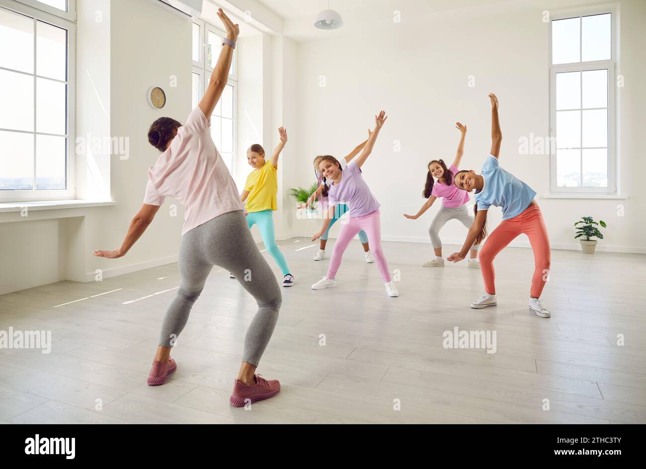 Woman choreographer showing her students girls stretching exercises in ...