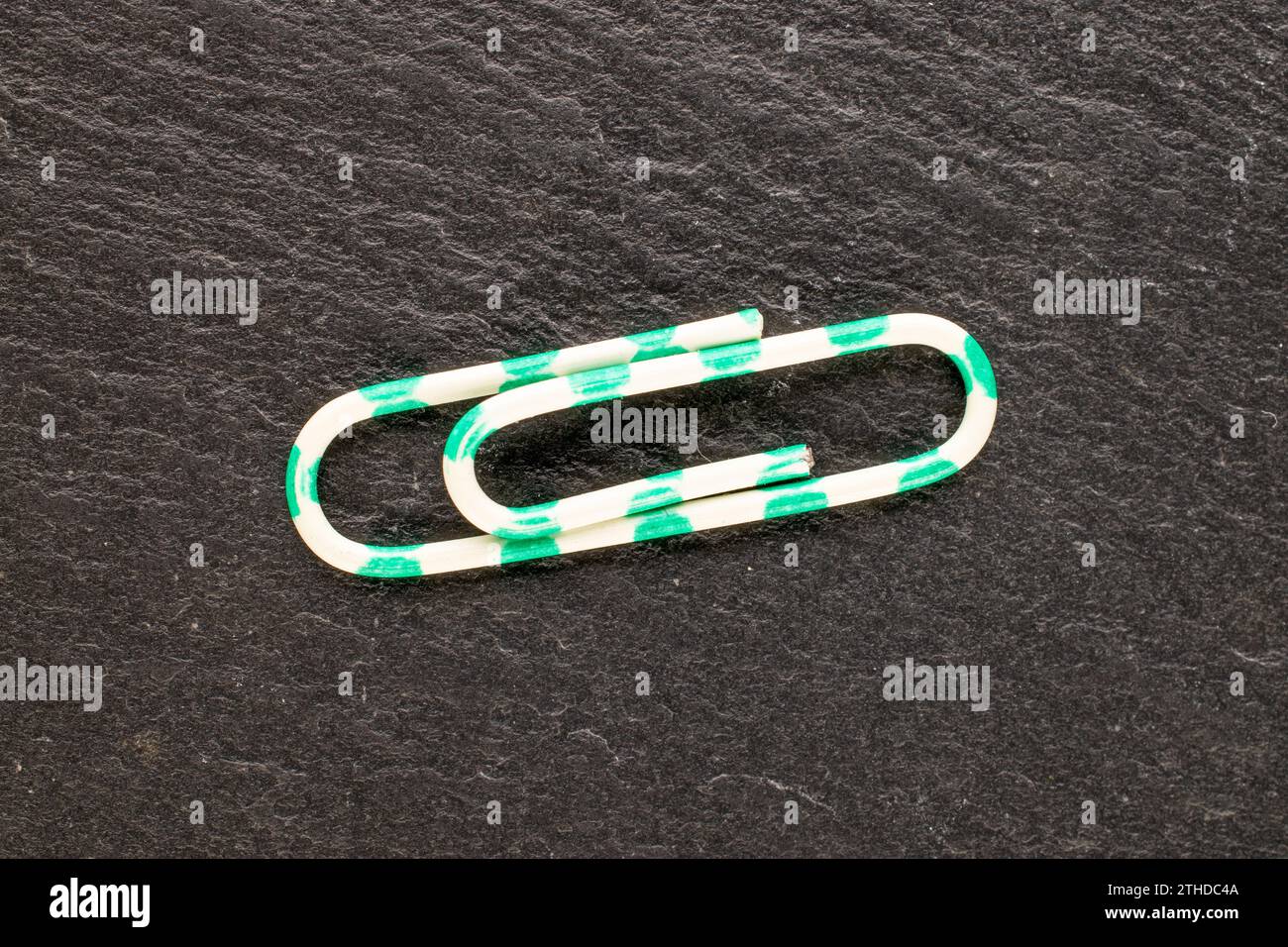 One metal clip on slate stone, macro, top view Stock Photo - Alamy