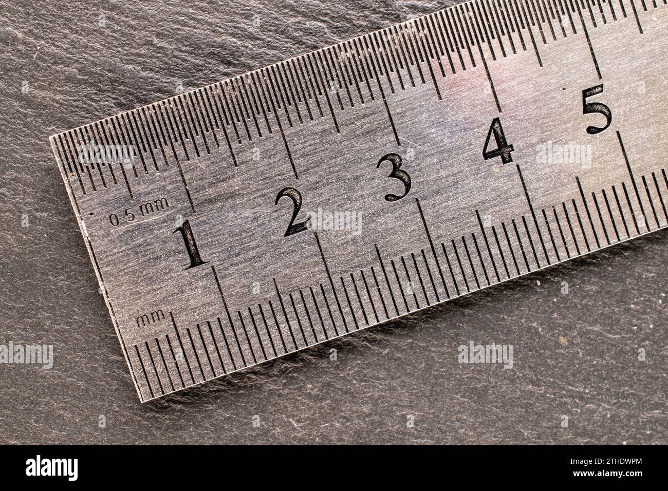One metal ruler on slate stone, macro, top view Stock Photo - Alamy