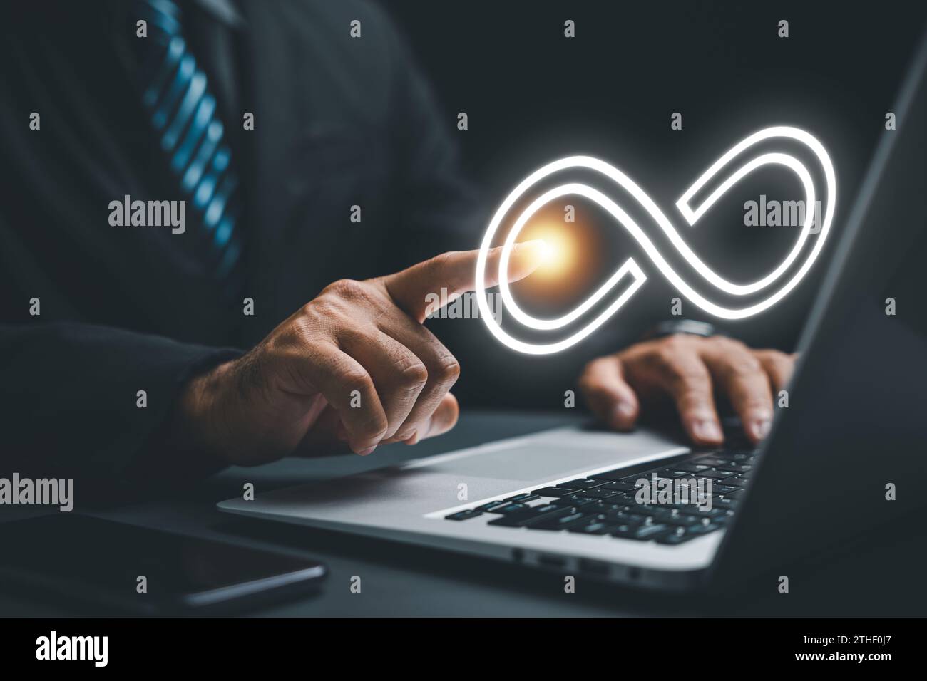 Businessman points to infinity symbol, representing limitless ...