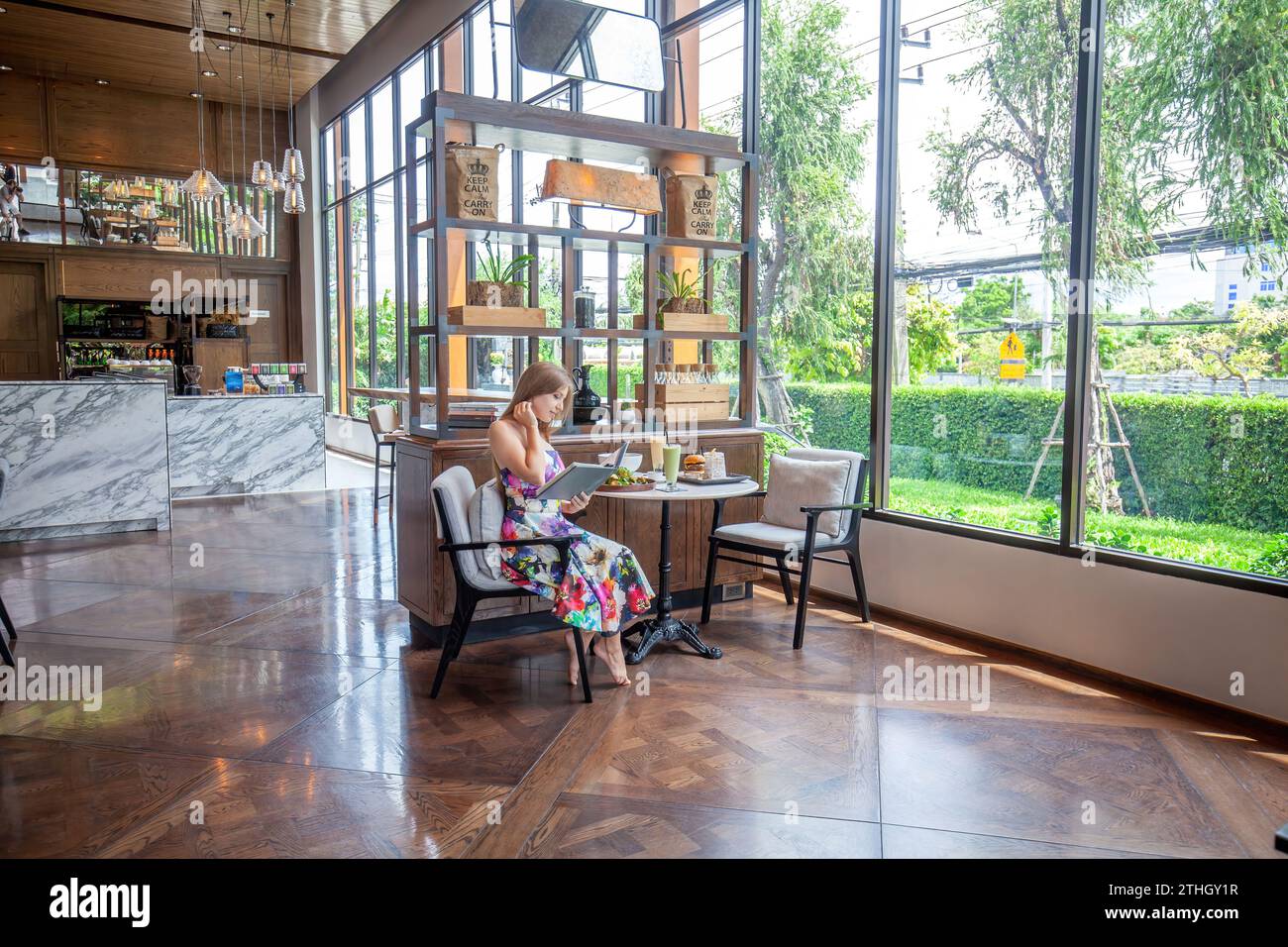 Modern cafe ambiance with individual examining menu book Stock Photo ...