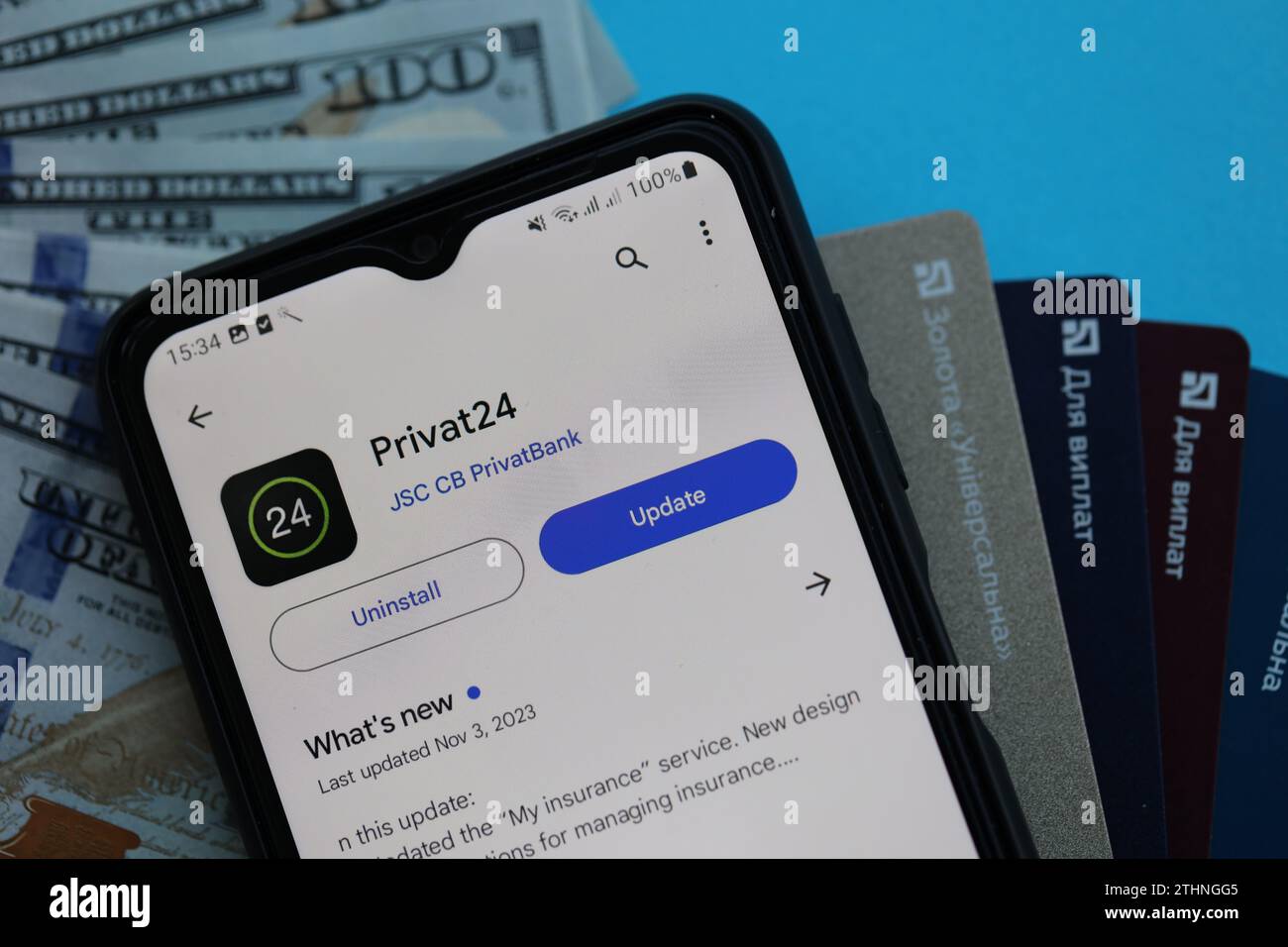 TERNOPIL, UKRAINE - JULY 7, 2023 Privatbank new banking plastic cards with money on table ...