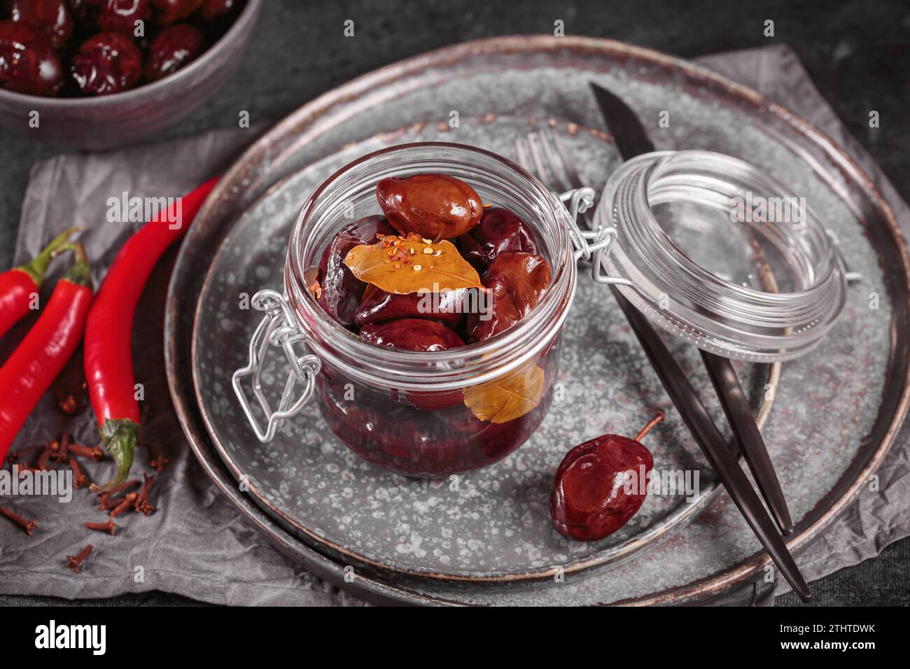 Marinated plums with spices in glass jar on the kitchen table Stock ...