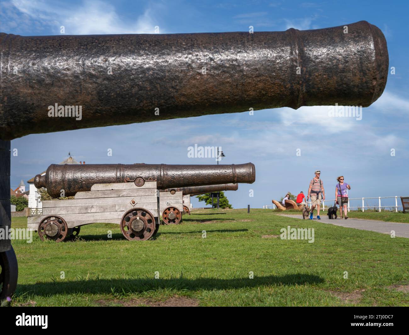 On a warm summer's day, tourists walk along the seafront at Gun Hill in ...